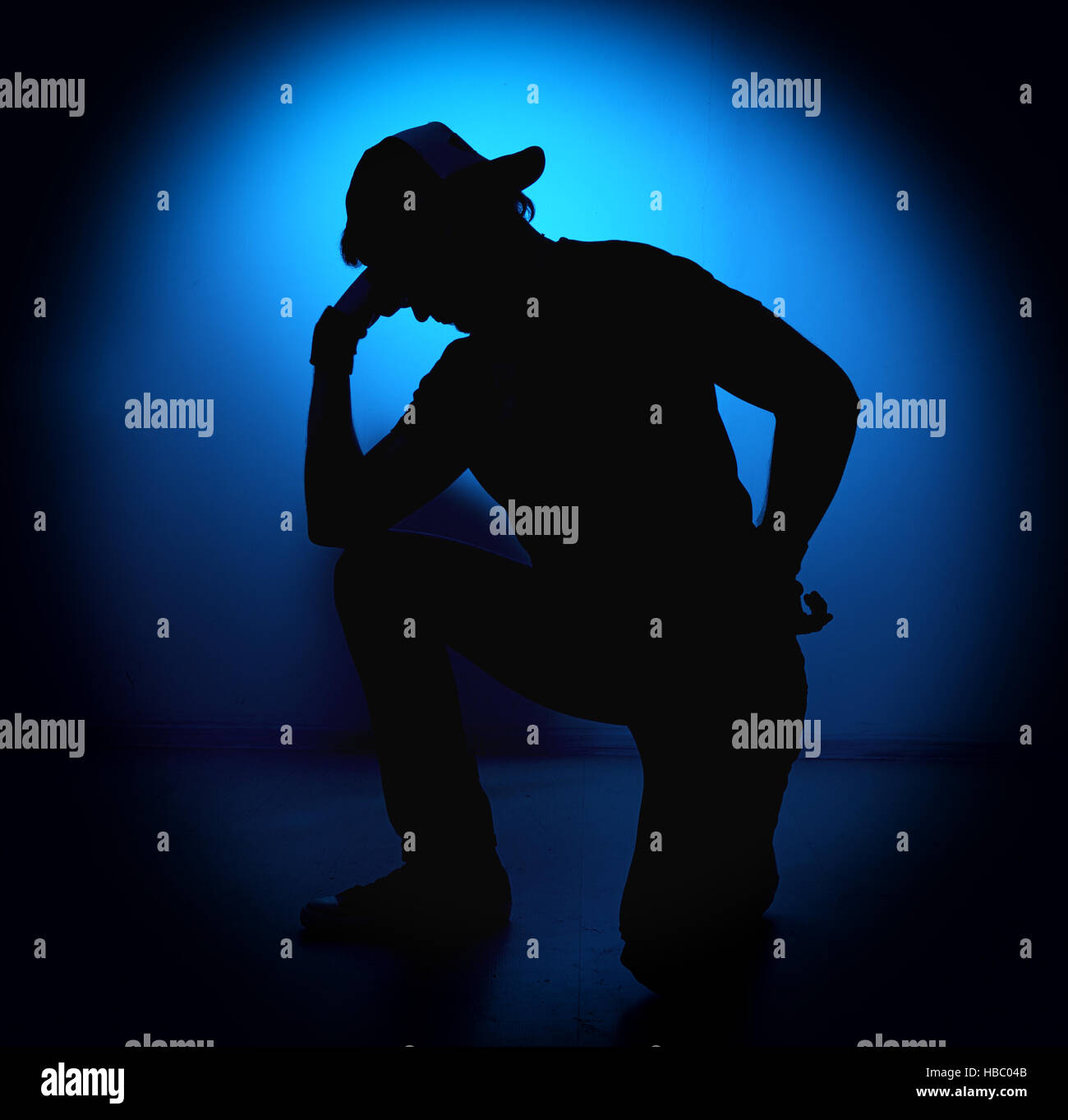 silhouette Rocker man posing on blue background Stock Photo - Alamy