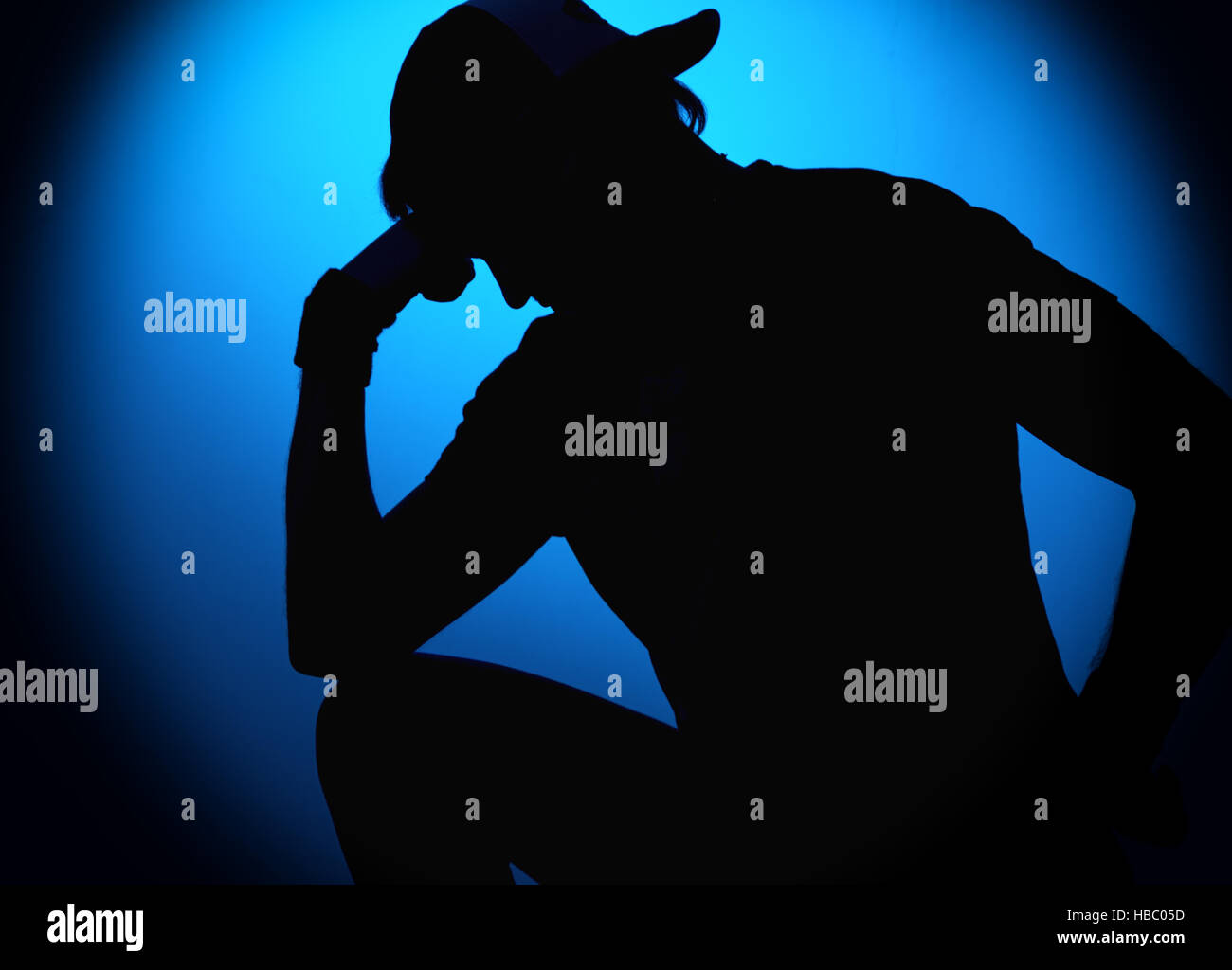 silhouette Rocker man posing on blue background Stock Photo - Alamy