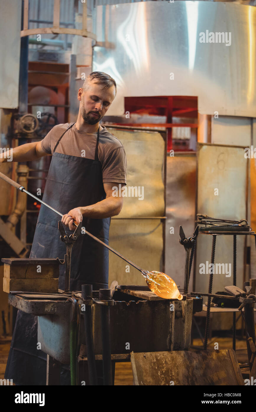 Glassblower shaping a molten glass Stock Photo - Alamy