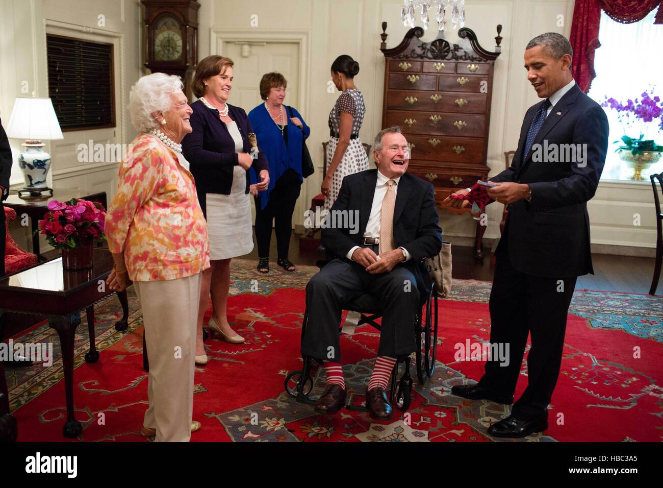 George H. W. and Barbara Bush present President Barack Obama with a ...