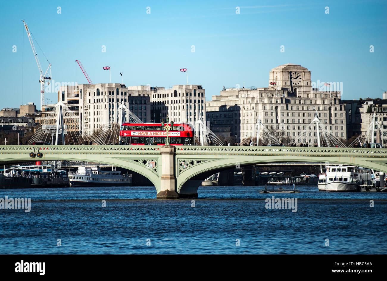 Modern red London bus on Westminster bridge on a winter's day looking ...
