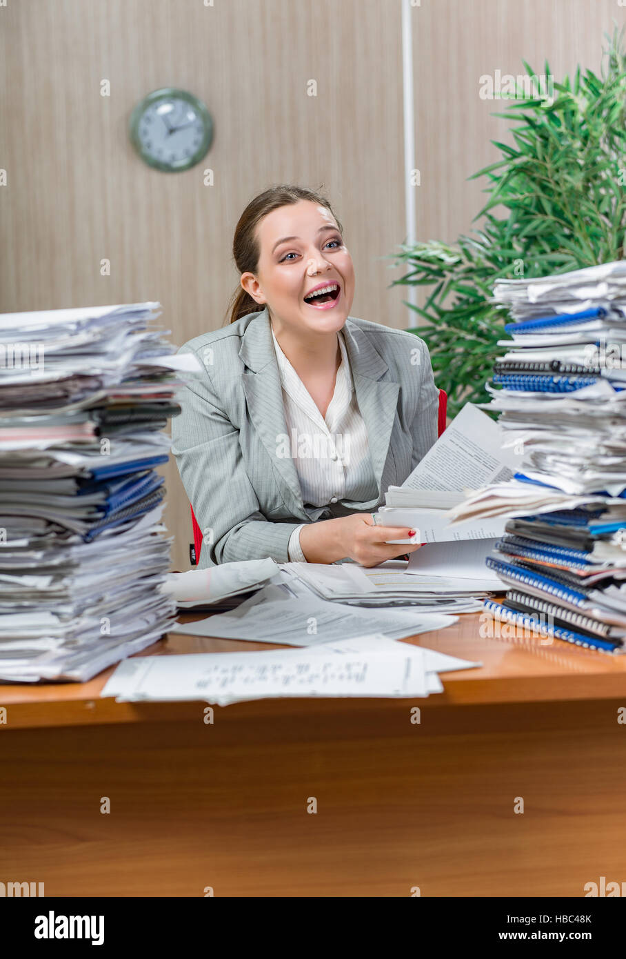 Woman under stress from excessive paper work Stock Photo - Alamy