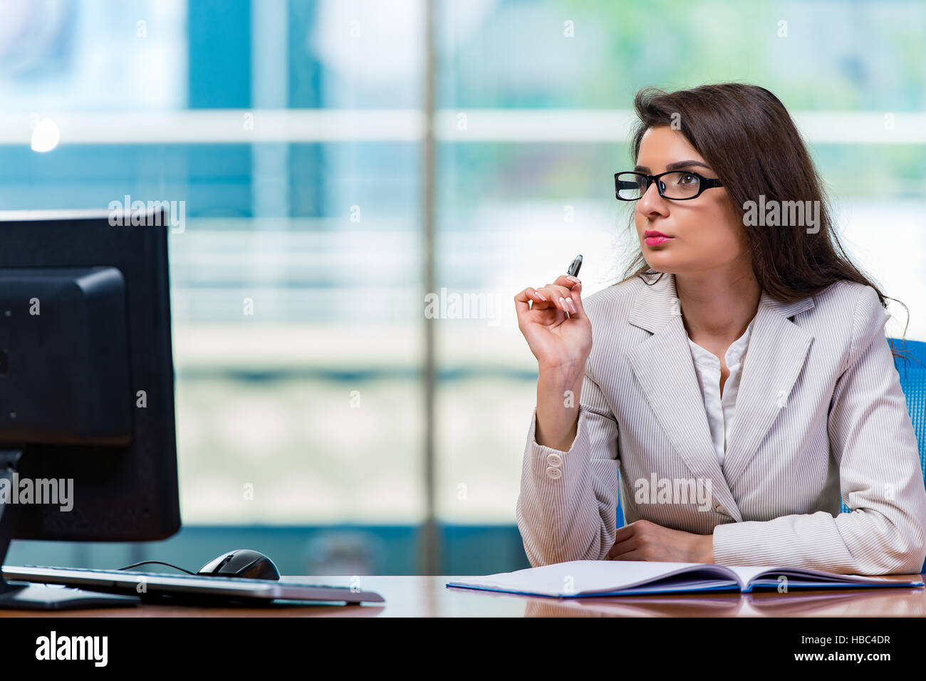 Businesswoman sitting at the office desk Stock Photo - Alamy