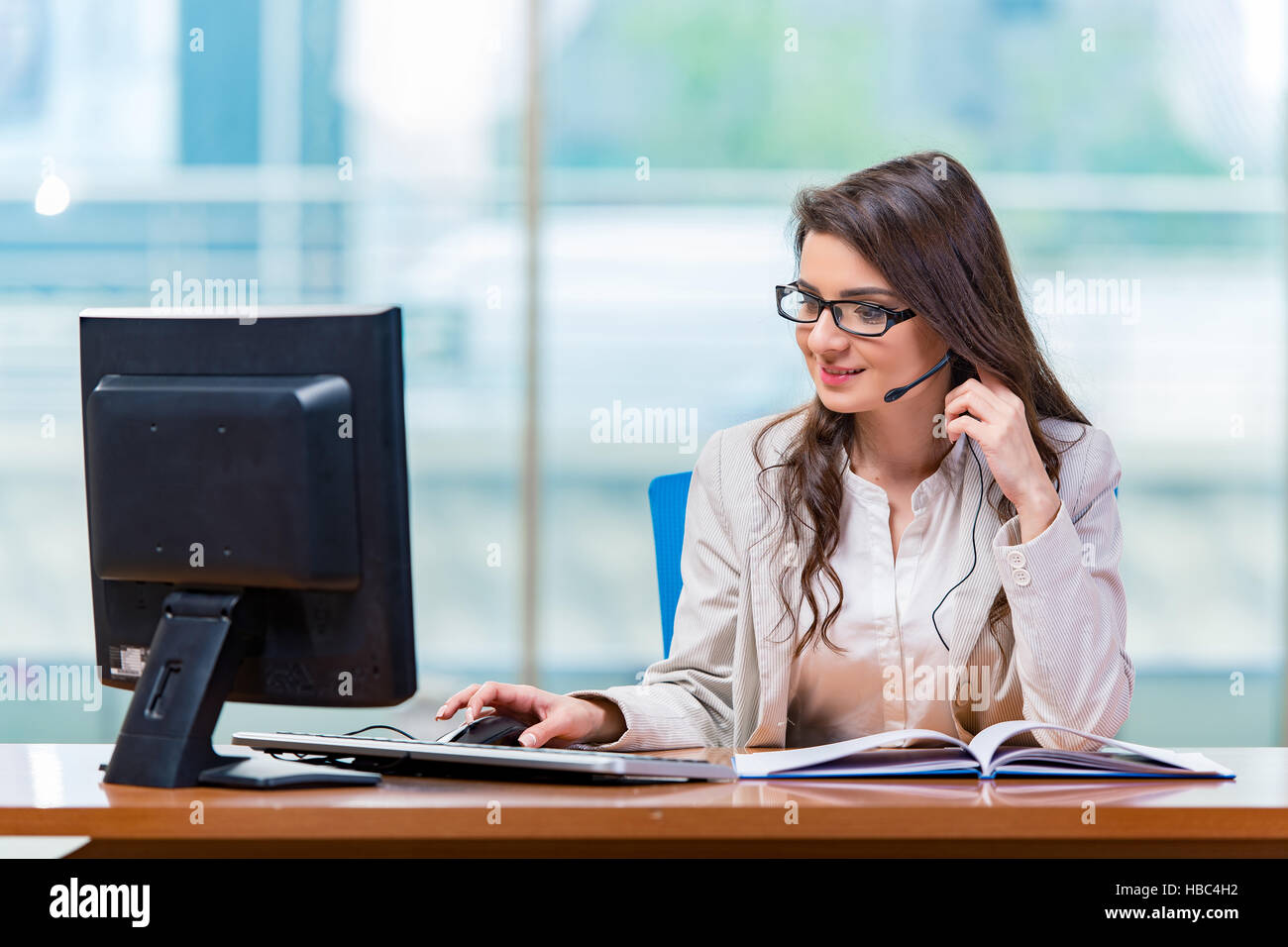 Call center operator working in the office Stock Photo - Alamy