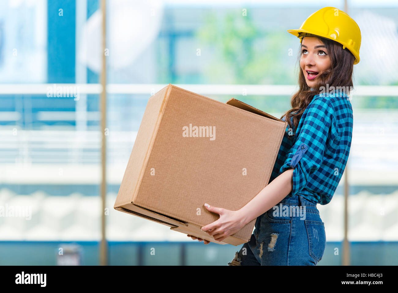 Nice young woman carrying box Stock Photo - Alamy