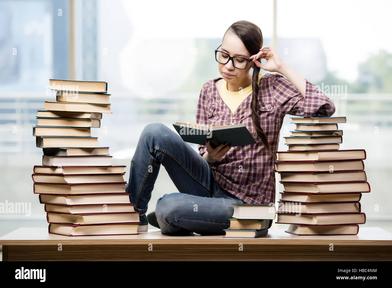 Young student with stack of books Stock Photo - Alamy