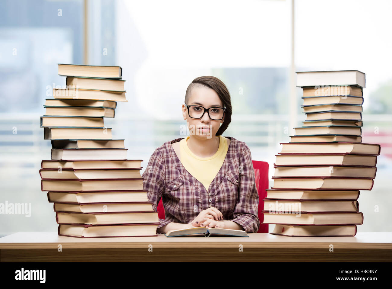 Young student with stack of books Stock Photo - Alamy