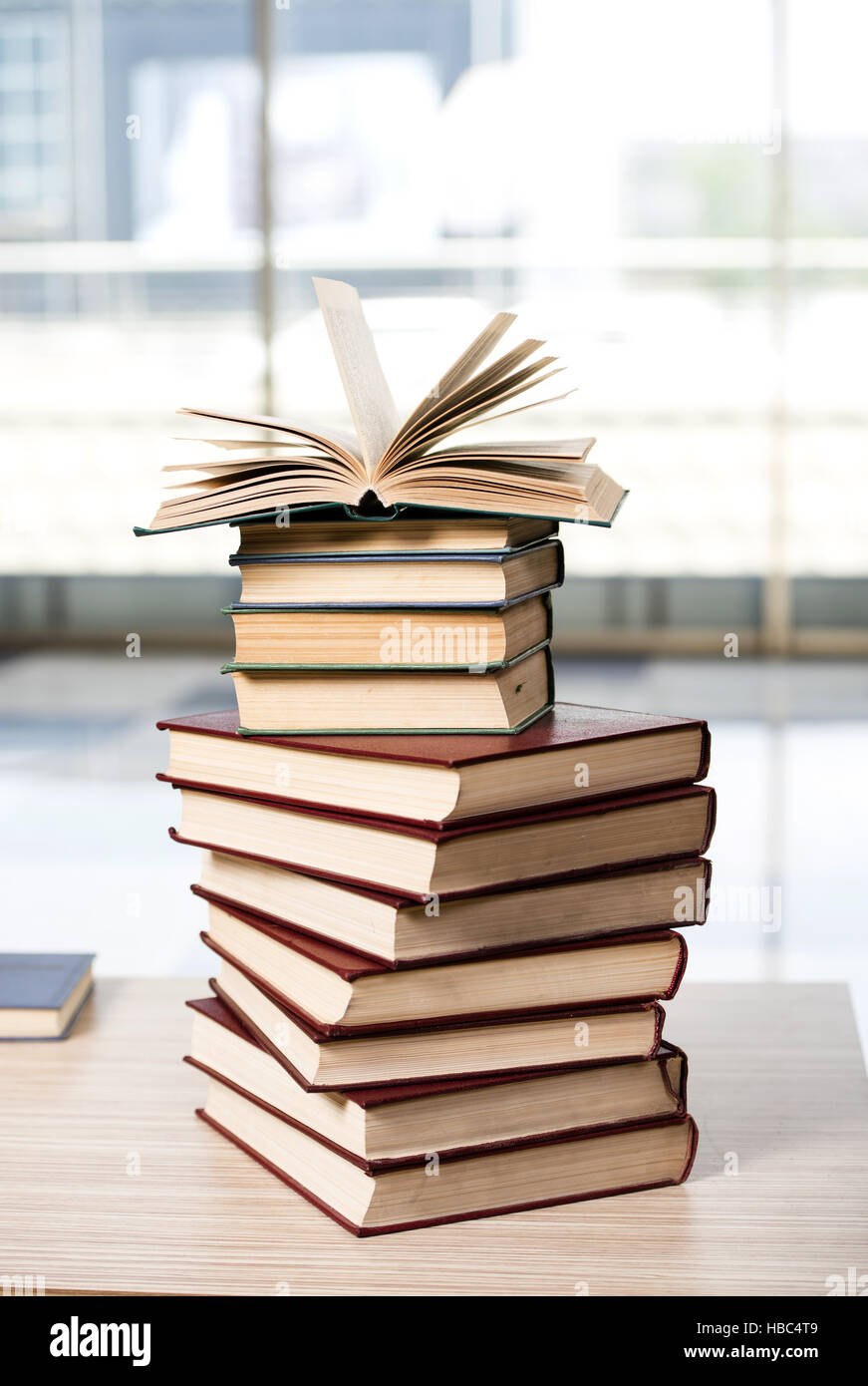 Stack of books arranged the office desk Stock Photo - Alamy