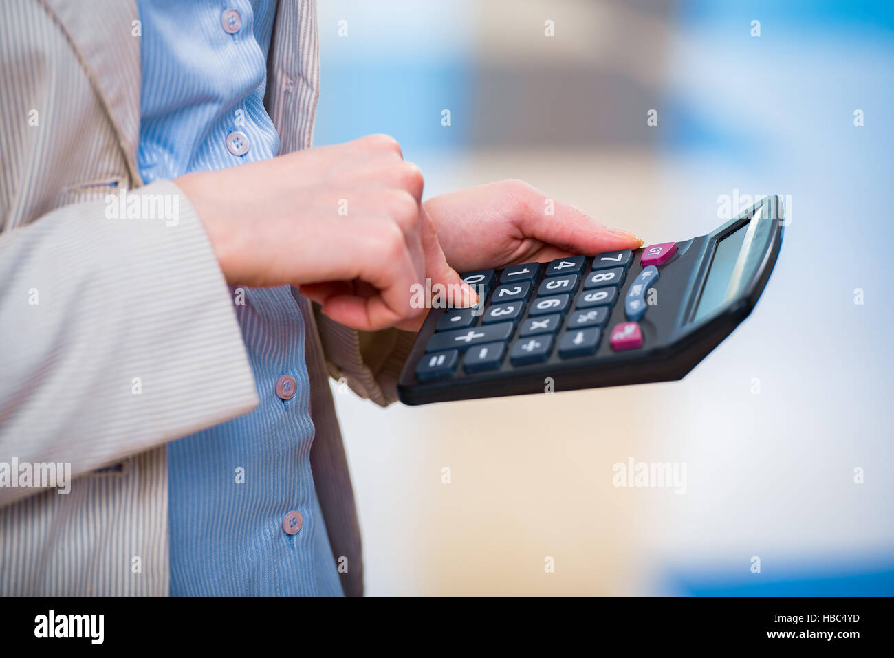 Hands calculating profit on the calculator Stock Photo - Alamy