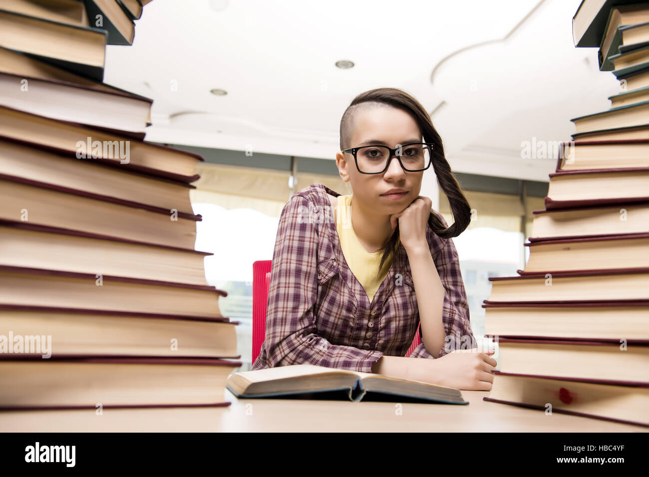 Young student with stack of books Stock Photo - Alamy