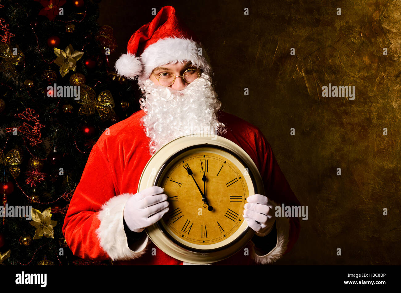 Santa with clock Stock Photo - Alamy
