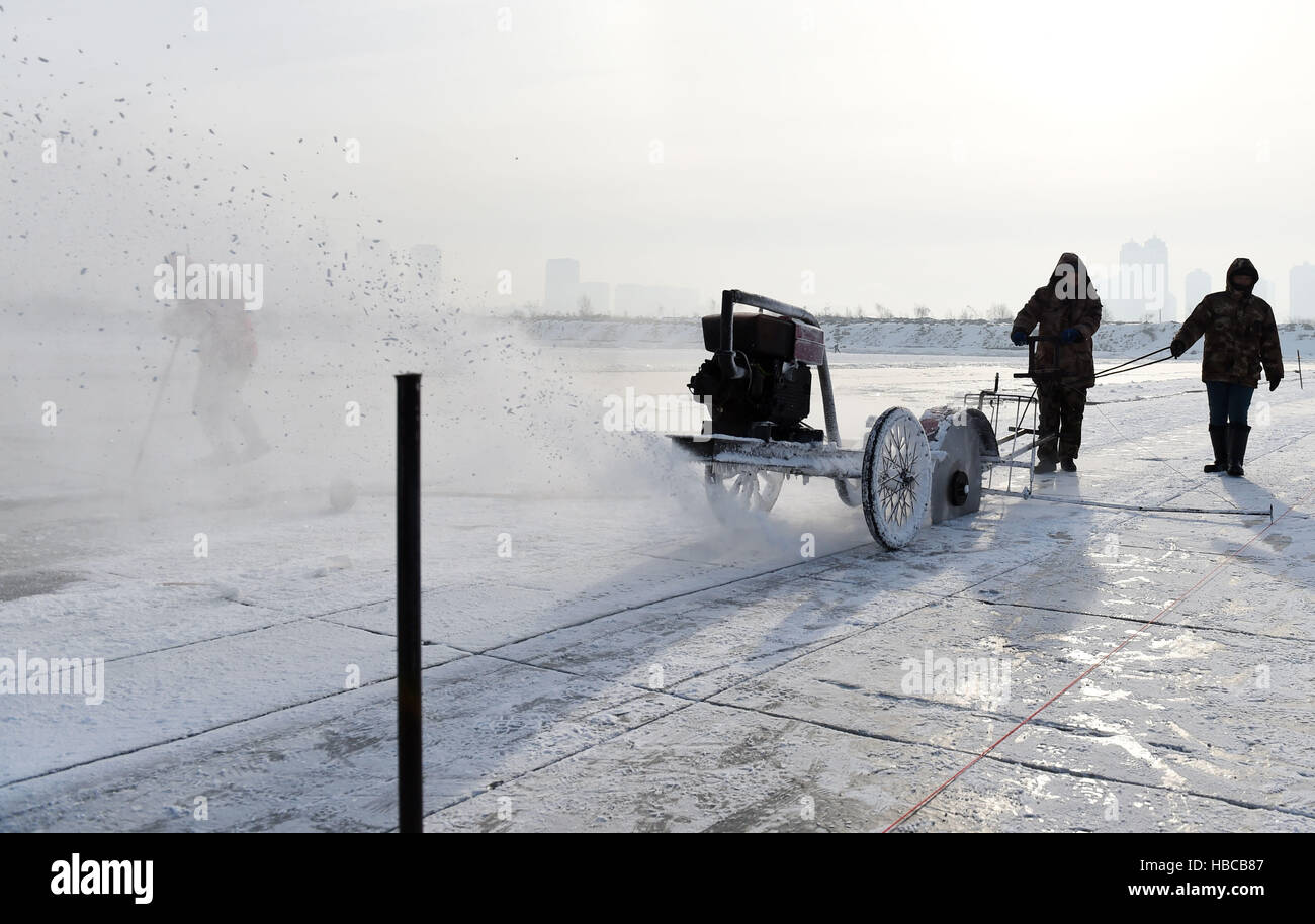 Harbin, China's Heilongjiang Province. 5th Dec, 2016. People cut ice on ...