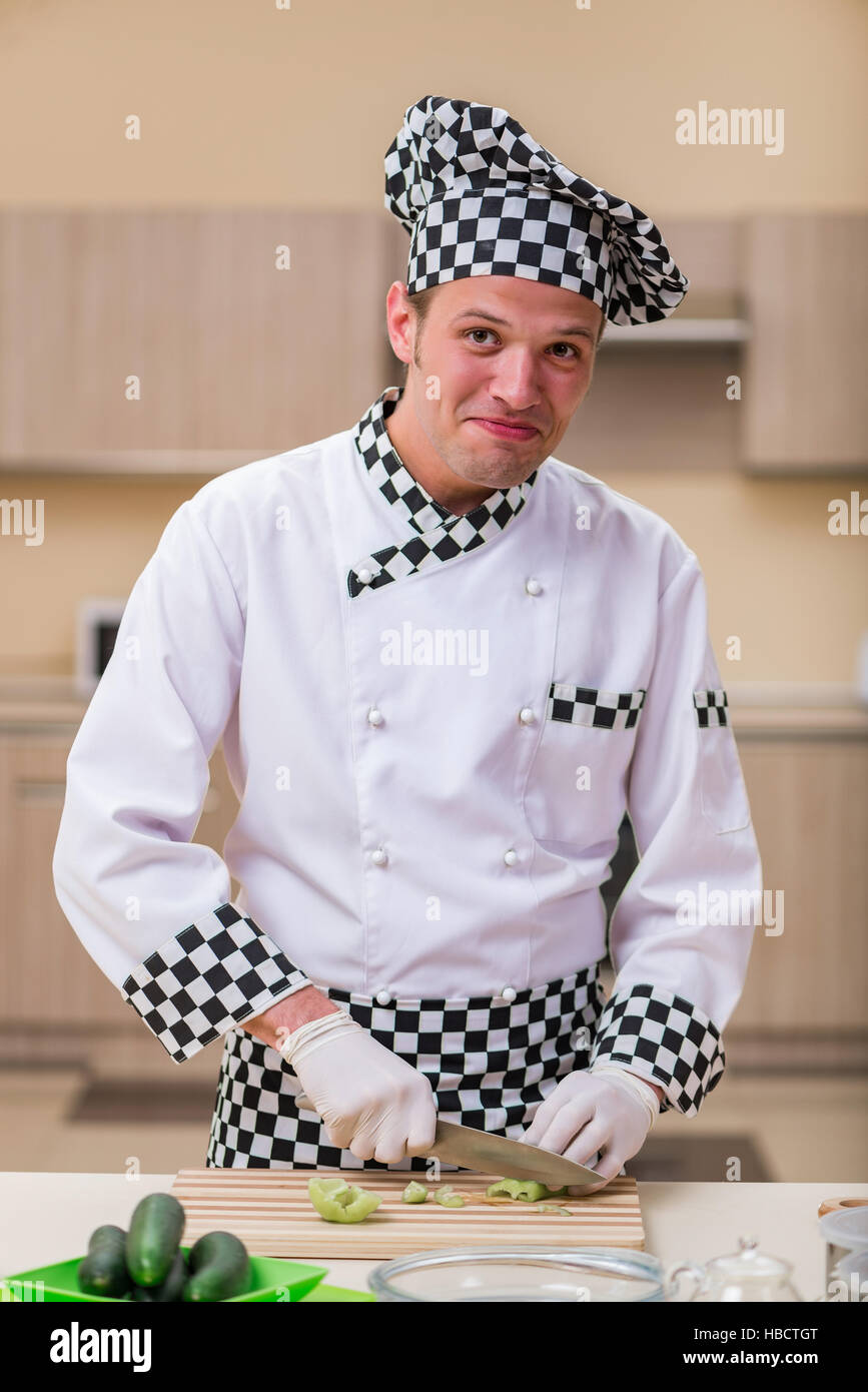 Male cook preparing food in the kitchen Stock Photo - Alamy