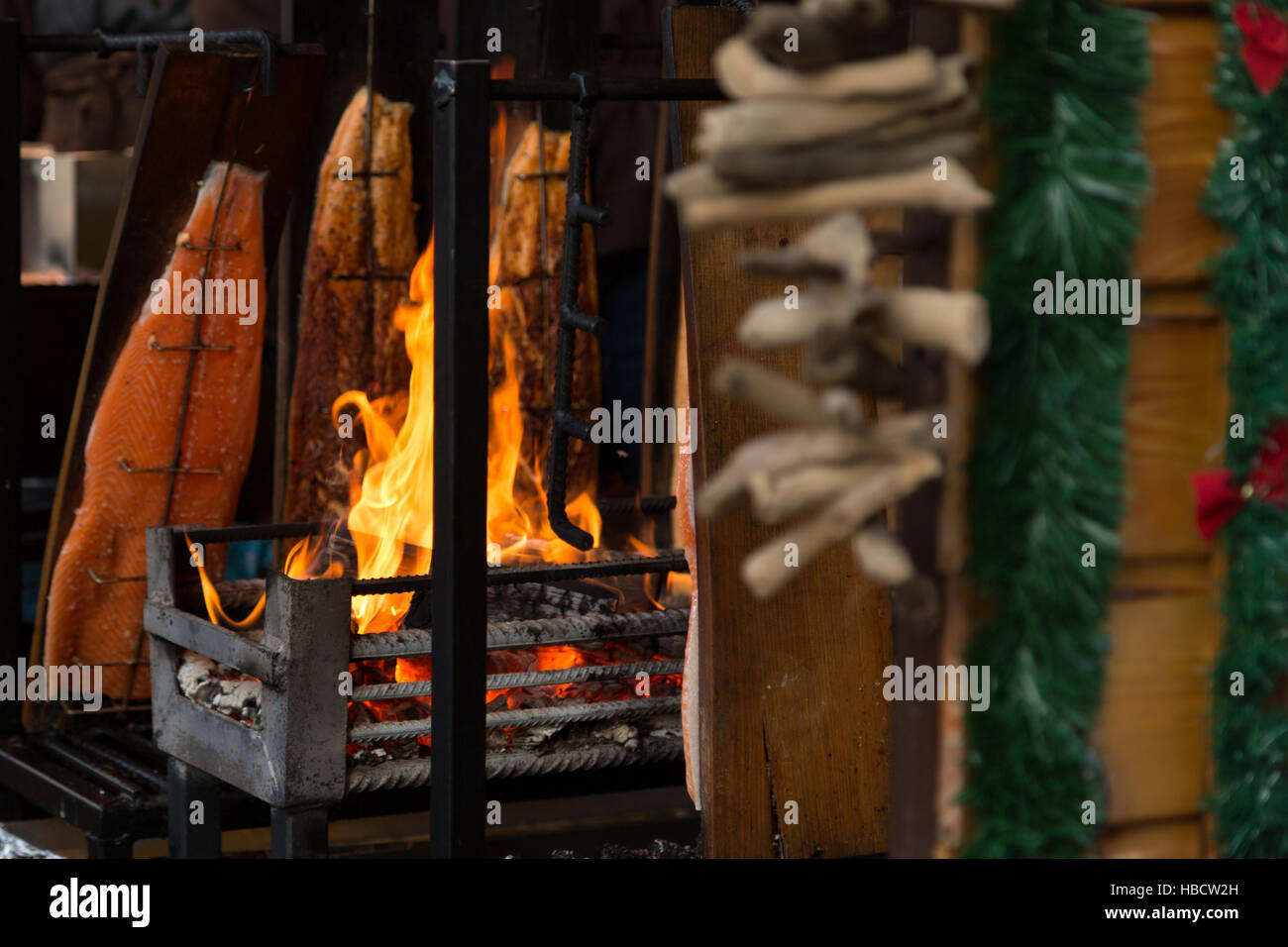 A photograph of some salmon being cooked over open flames at the ...