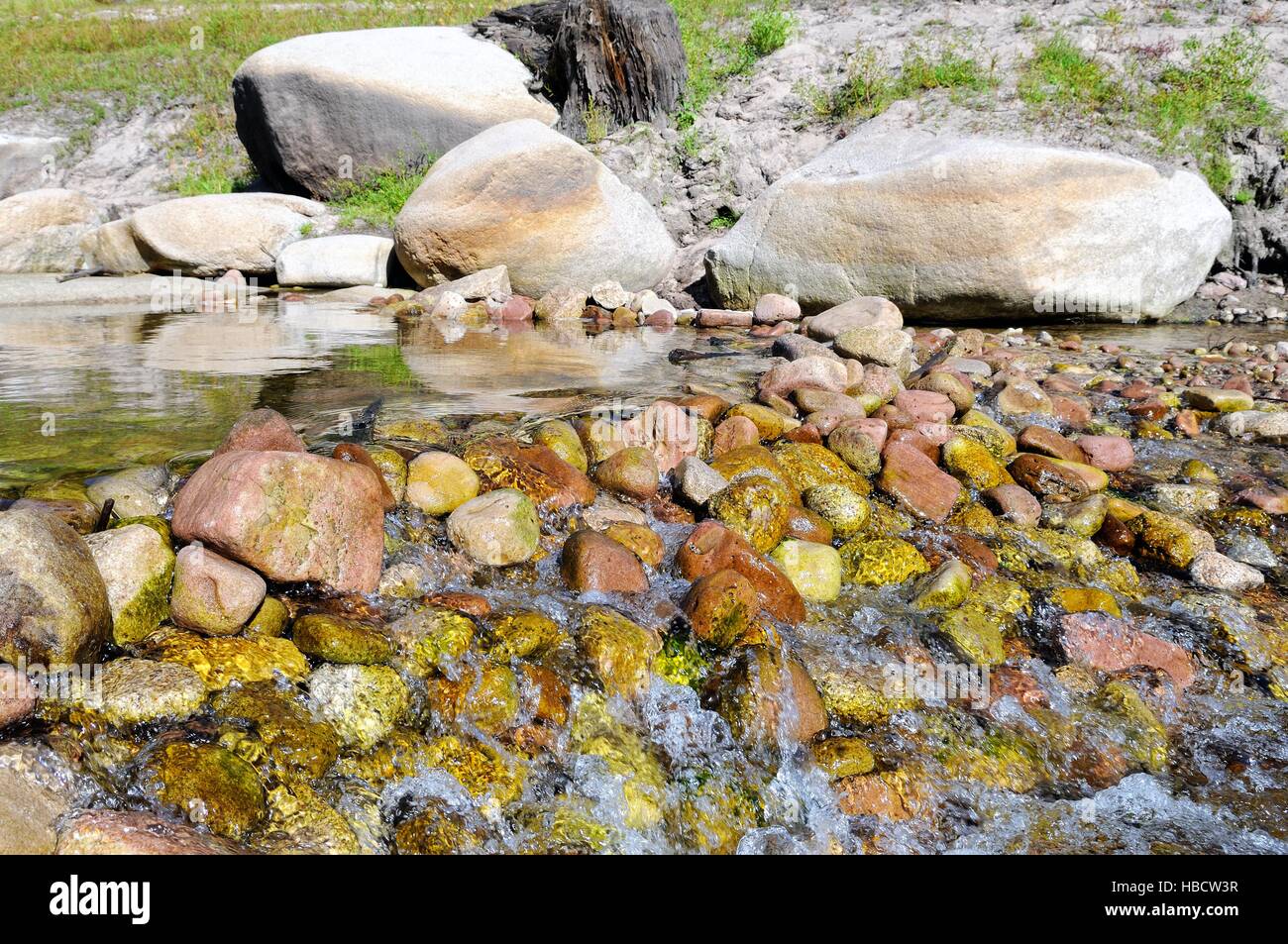 Stone barrier in the river Stock Photo - Alamy