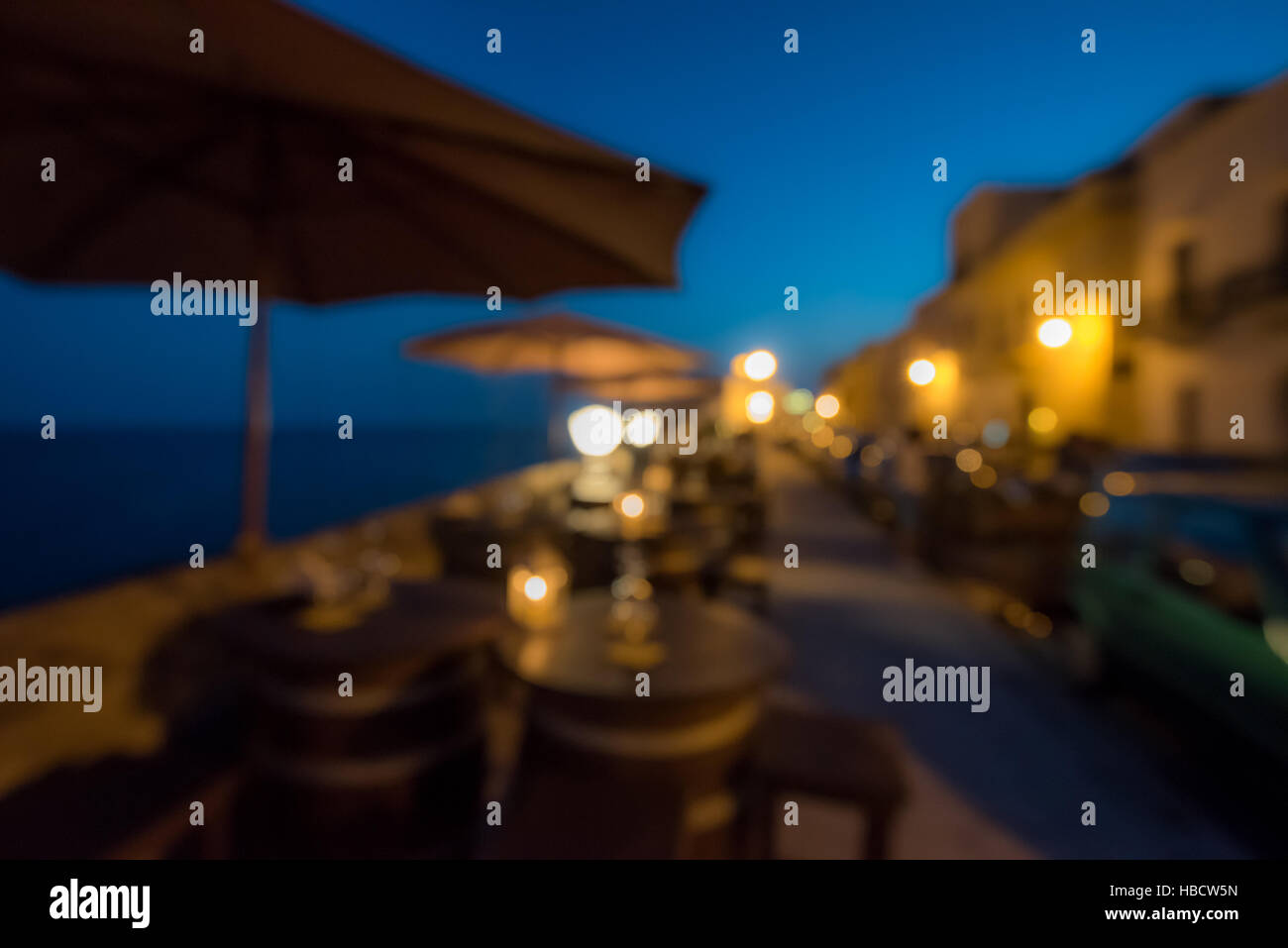 Seaside bar, defocused night scene Stock Photo - Alamy