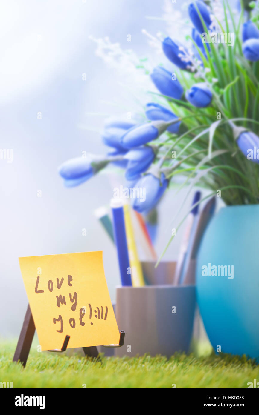 Adhesive note with Love my job text at green office Stock Photo - Alamy