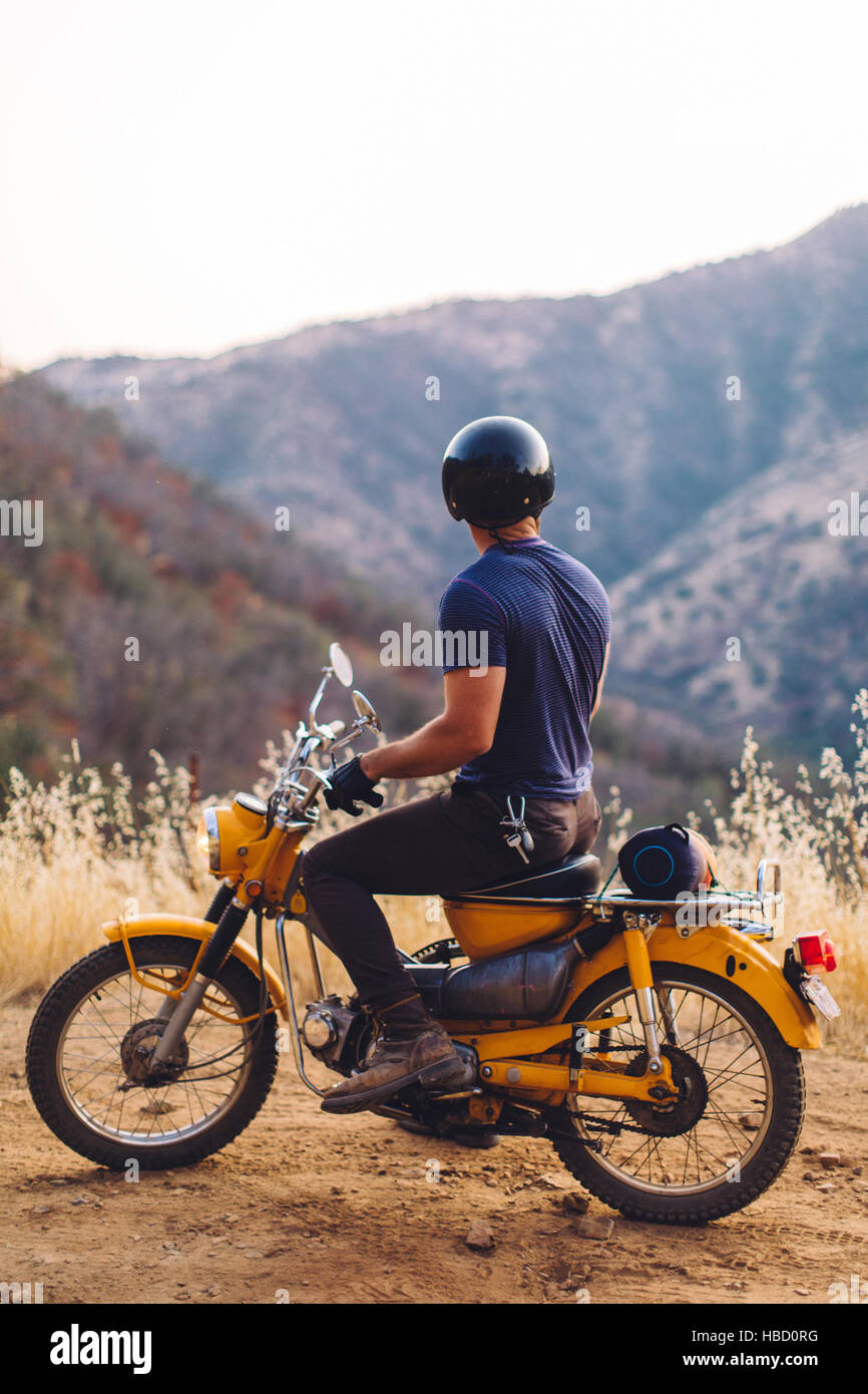 Man sitting on motorbike, looking at view, rear view, Sequoia National ...