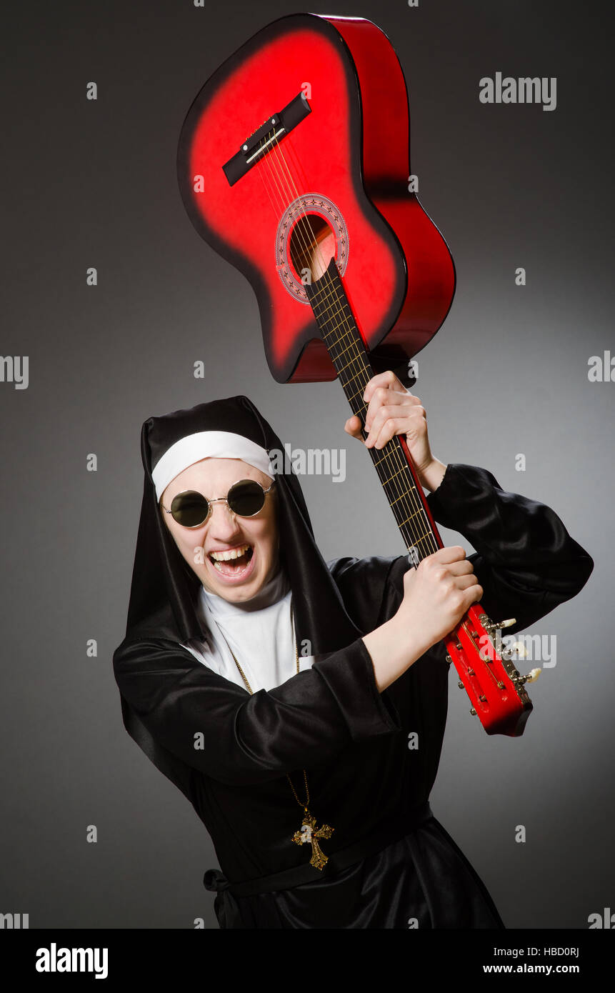 Funny nun with red guitar playing Stock Photo - Alamy