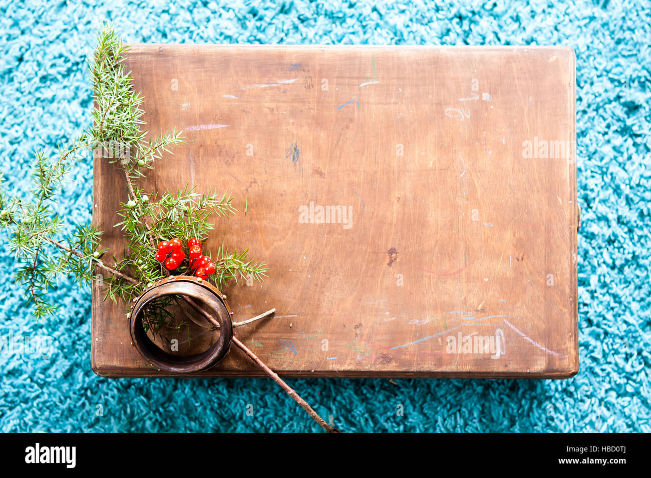 box with wooden texture and fir tree on fluffy blue carpet background ...
