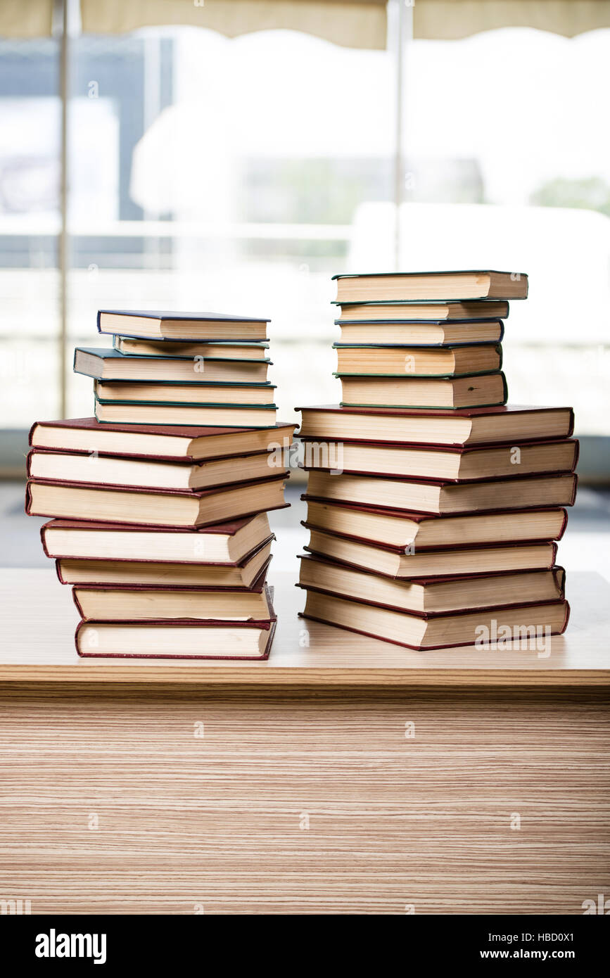 Stack of books arranged the office desk Stock Photo - Alamy