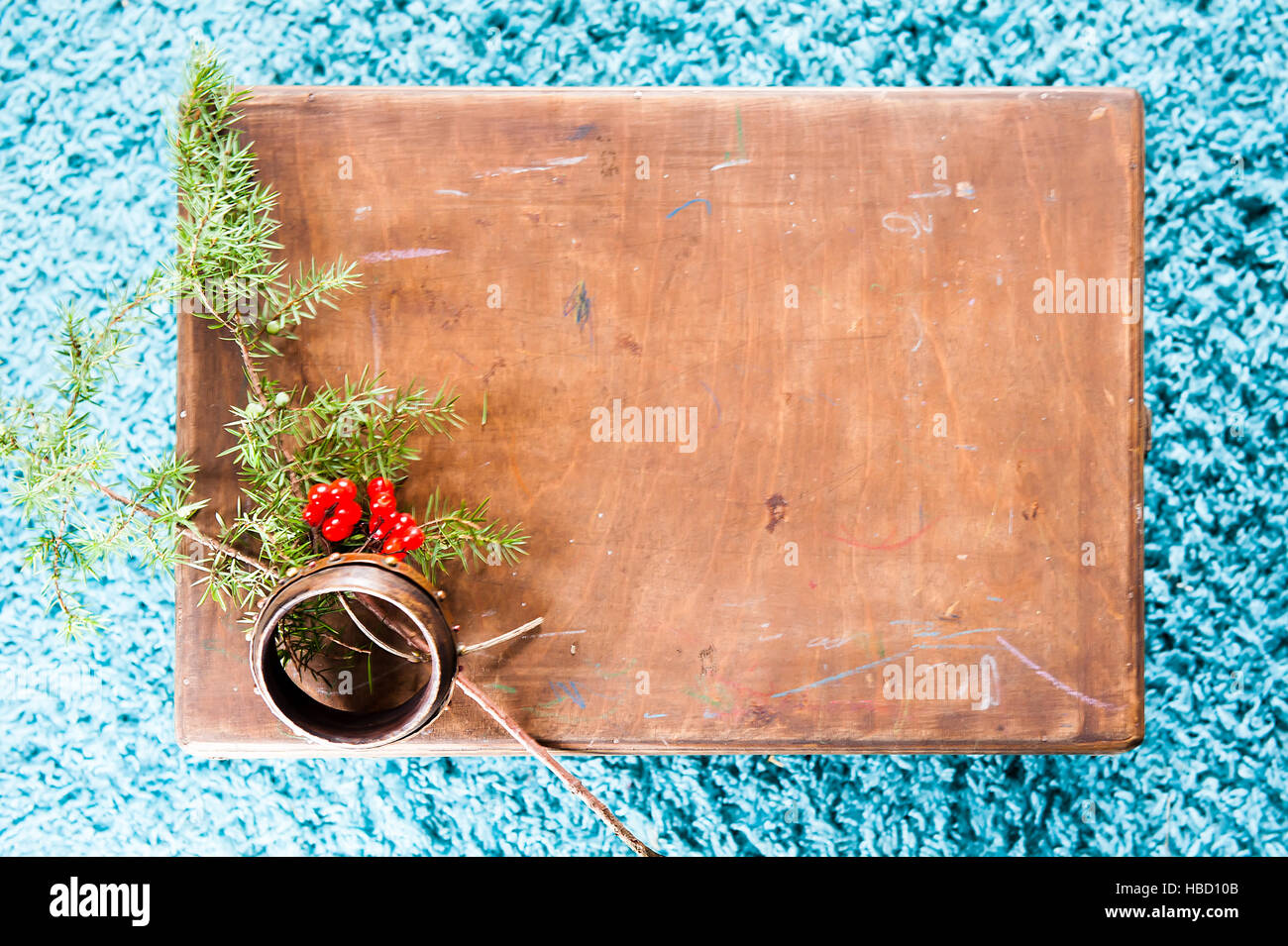 box with wooden texture and fir tree on fluffy blue carpet background ...