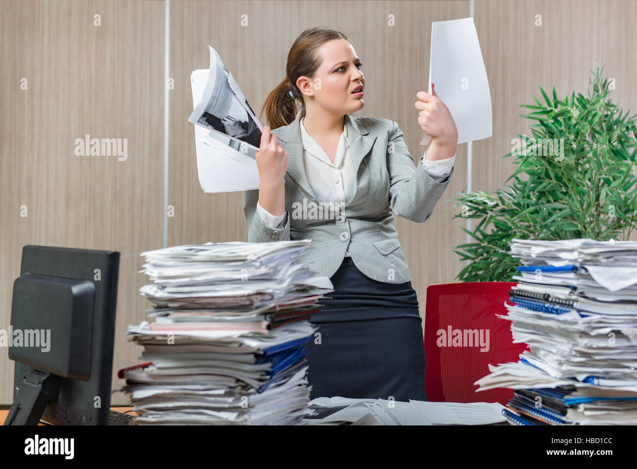 Woman under stress from excessive paper work Stock Photo - Alamy
