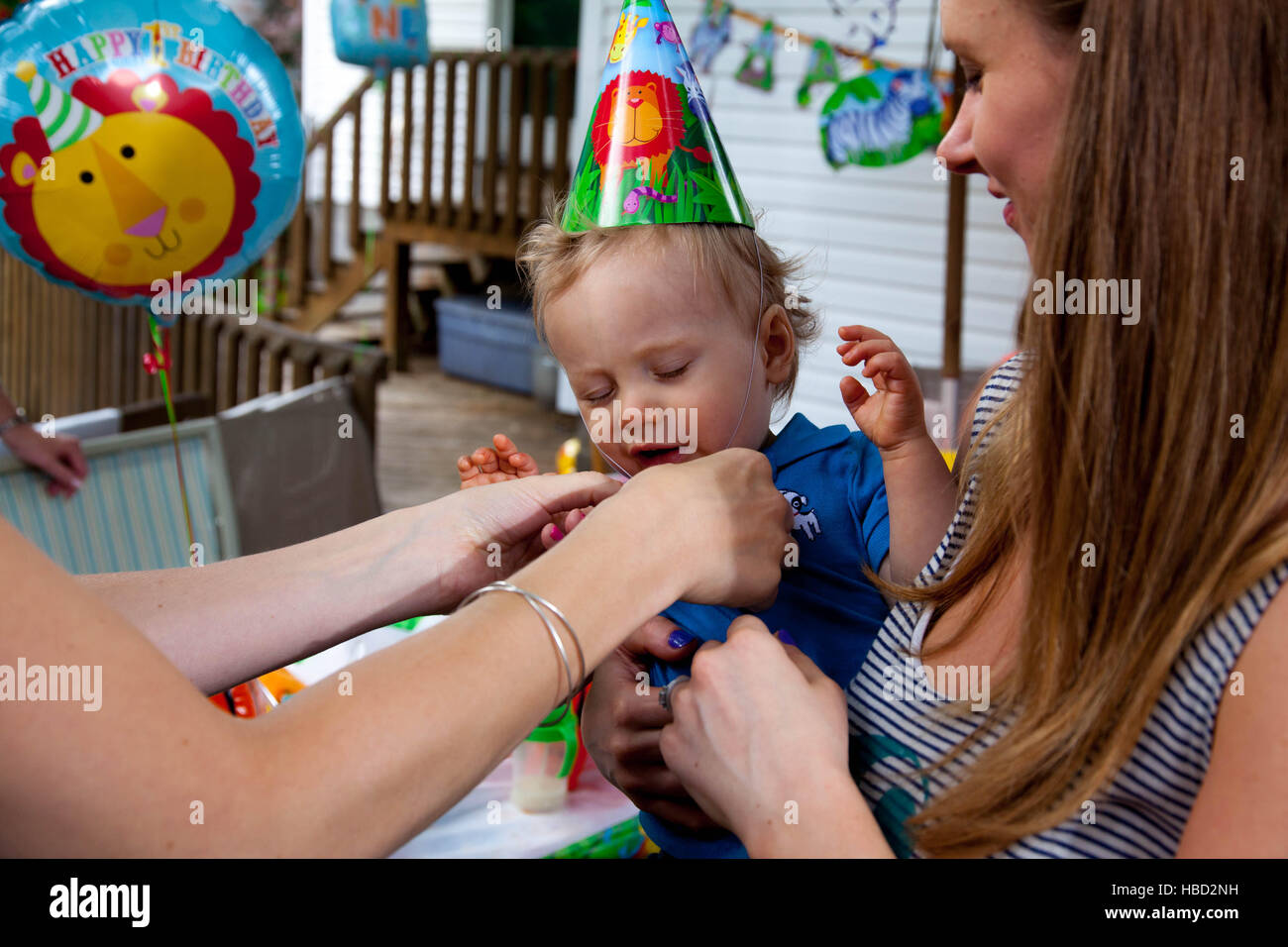 Young Caucasian boy celebrates his first birthday with his Mother ...
