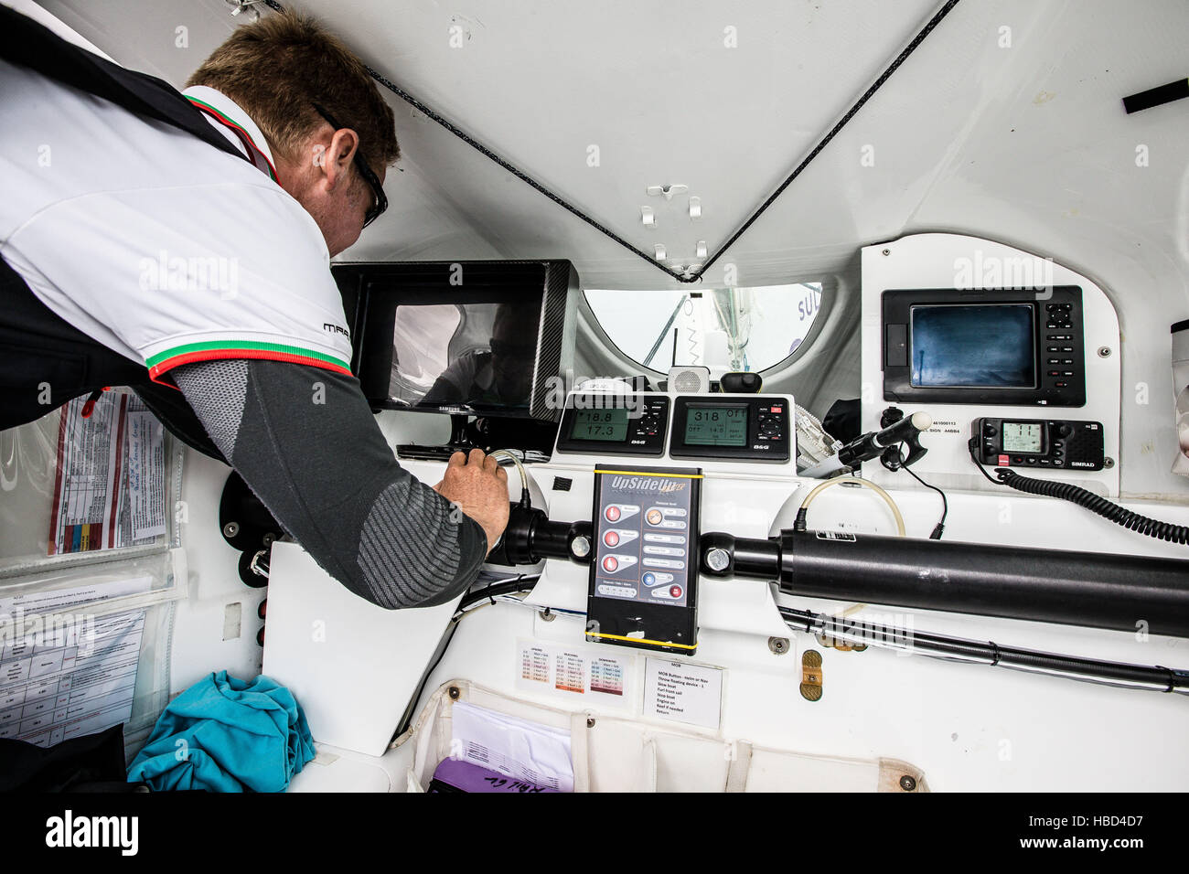 A sailor is checking the instruments inside the Oman Sail's Trimaran ...