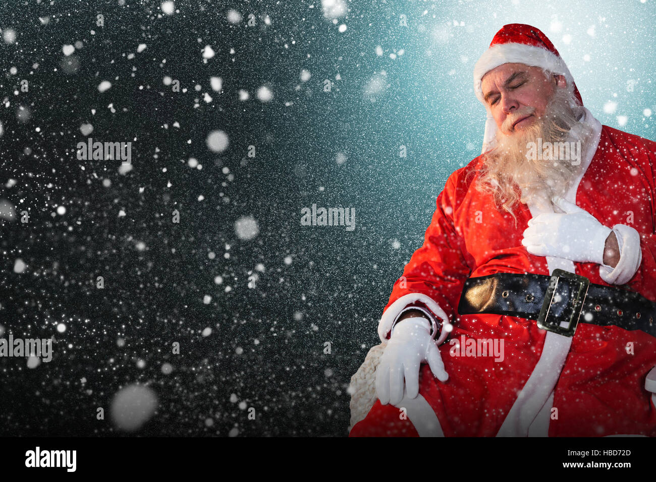 Composite image of santa claus relaxing on chair Stock Photo - Alamy