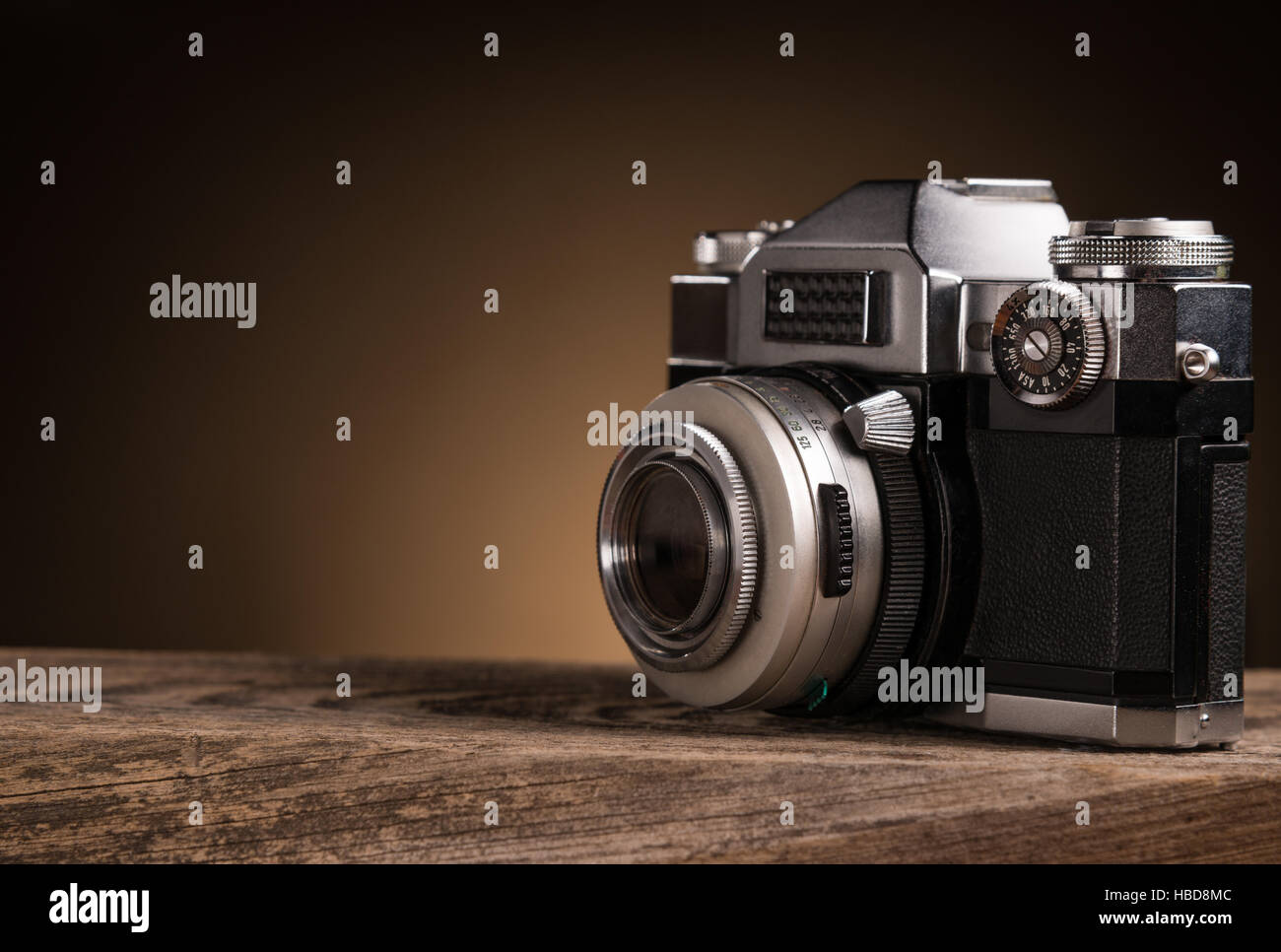 Old-fashioned photo camera on wooden table Stock Photo - Alamy