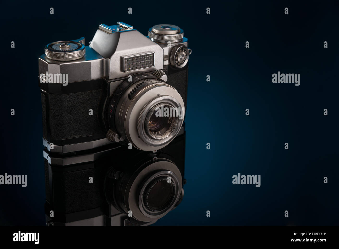 Retro slr camera on dark blue background Stock Photo - Alamy