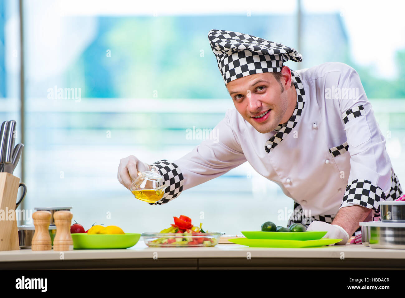 The male cook preparing food in the kitchen Stock Photo - Alamy