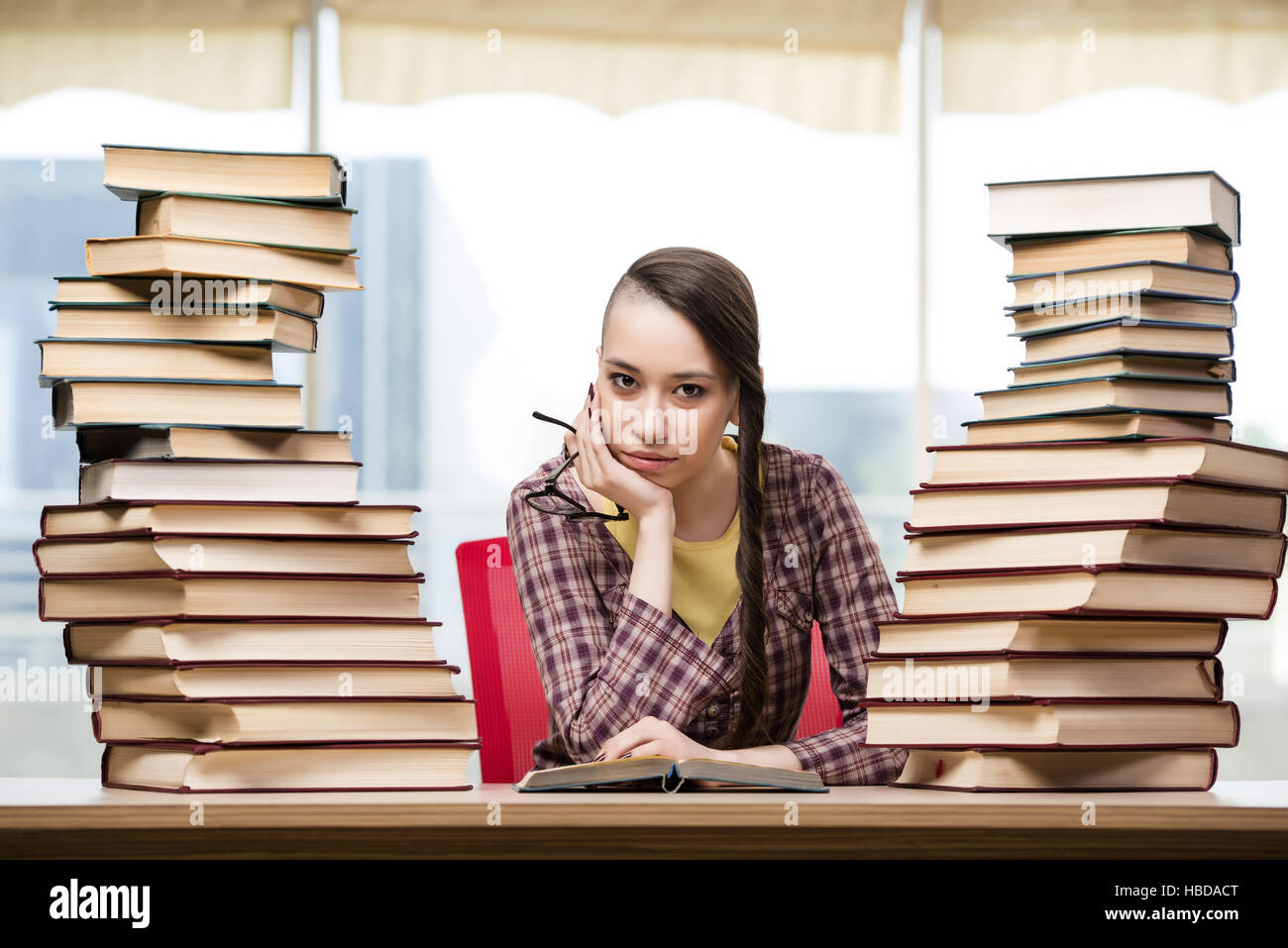 The young student with stack of books Stock Photo - Alamy