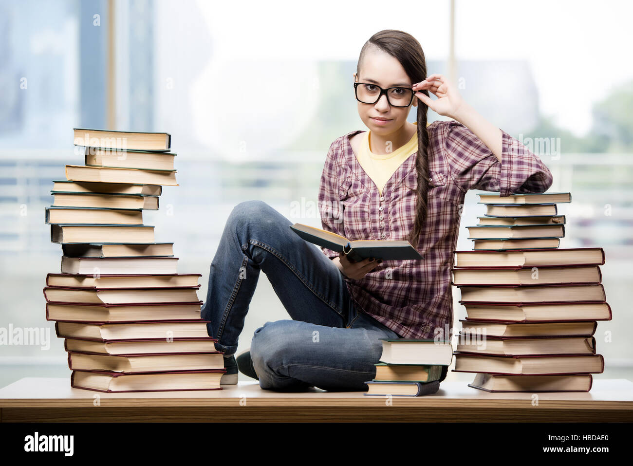 The young student with stack of books Stock Photo - Alamy