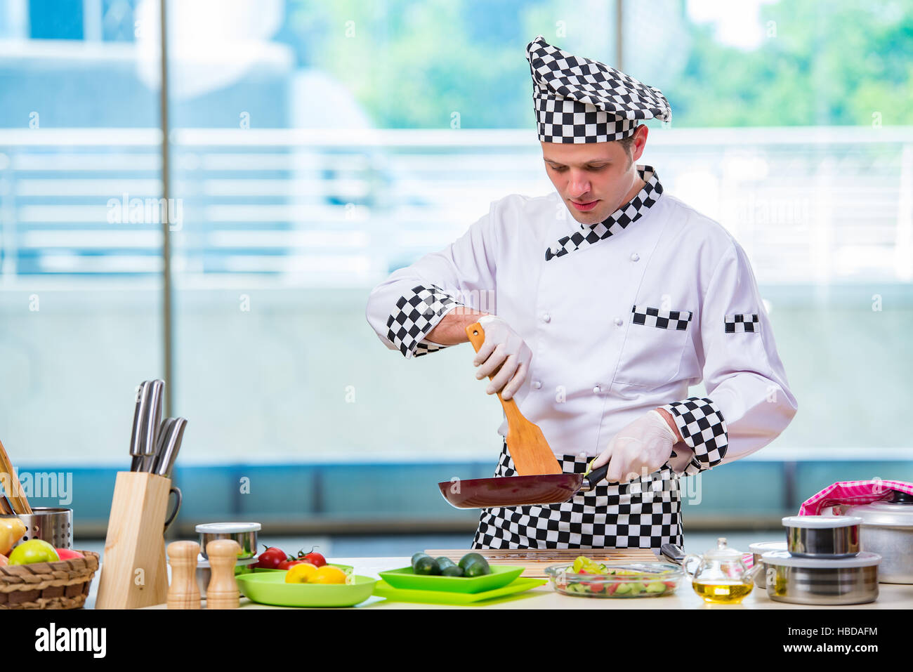 The male cook preparing food in the kitchen Stock Photo - Alamy