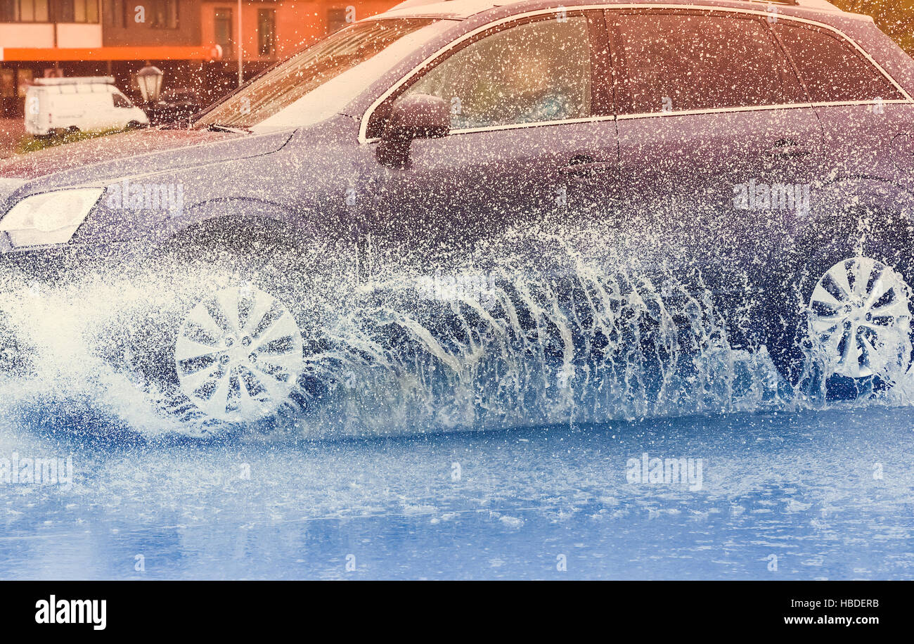 car rain puddle splashing water Stock Photo - Alamy