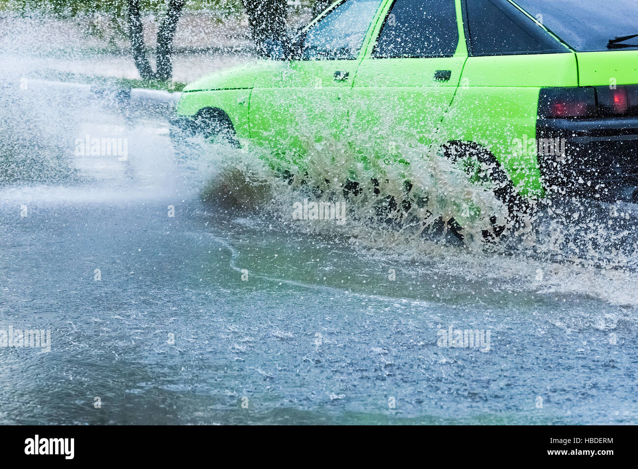 car rain puddle splashing water Stock Photo - Alamy