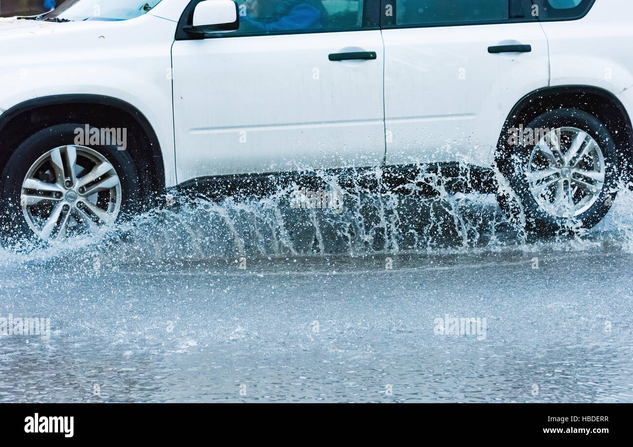 car rain puddle splashing water Stock Photo - Alamy