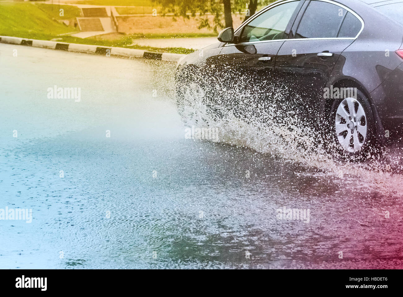 car rain puddle splashing water Stock Photo - Alamy