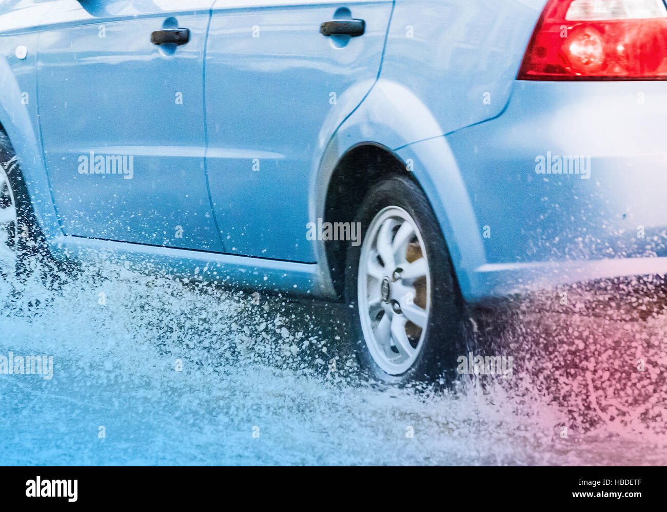 car rain puddle splashing water Stock Photo - Alamy