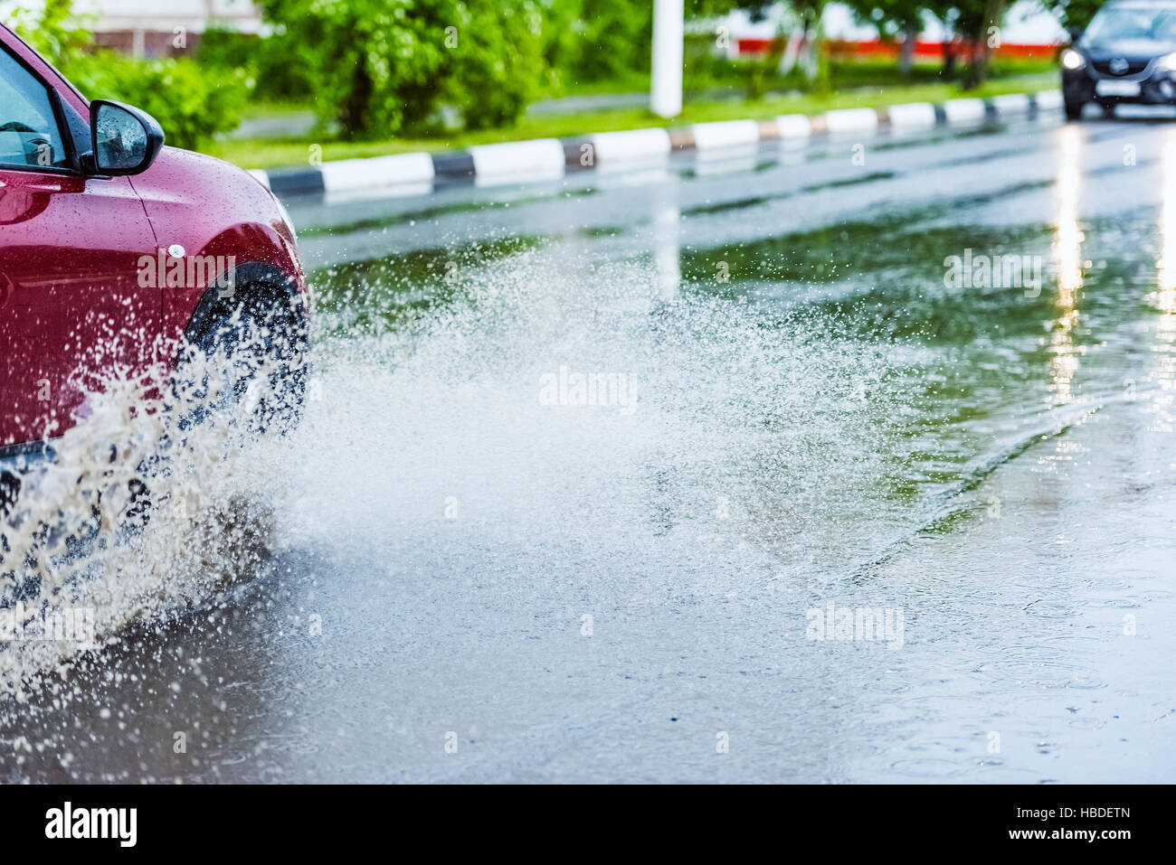 car rain puddle splashing water Stock Photo - Alamy