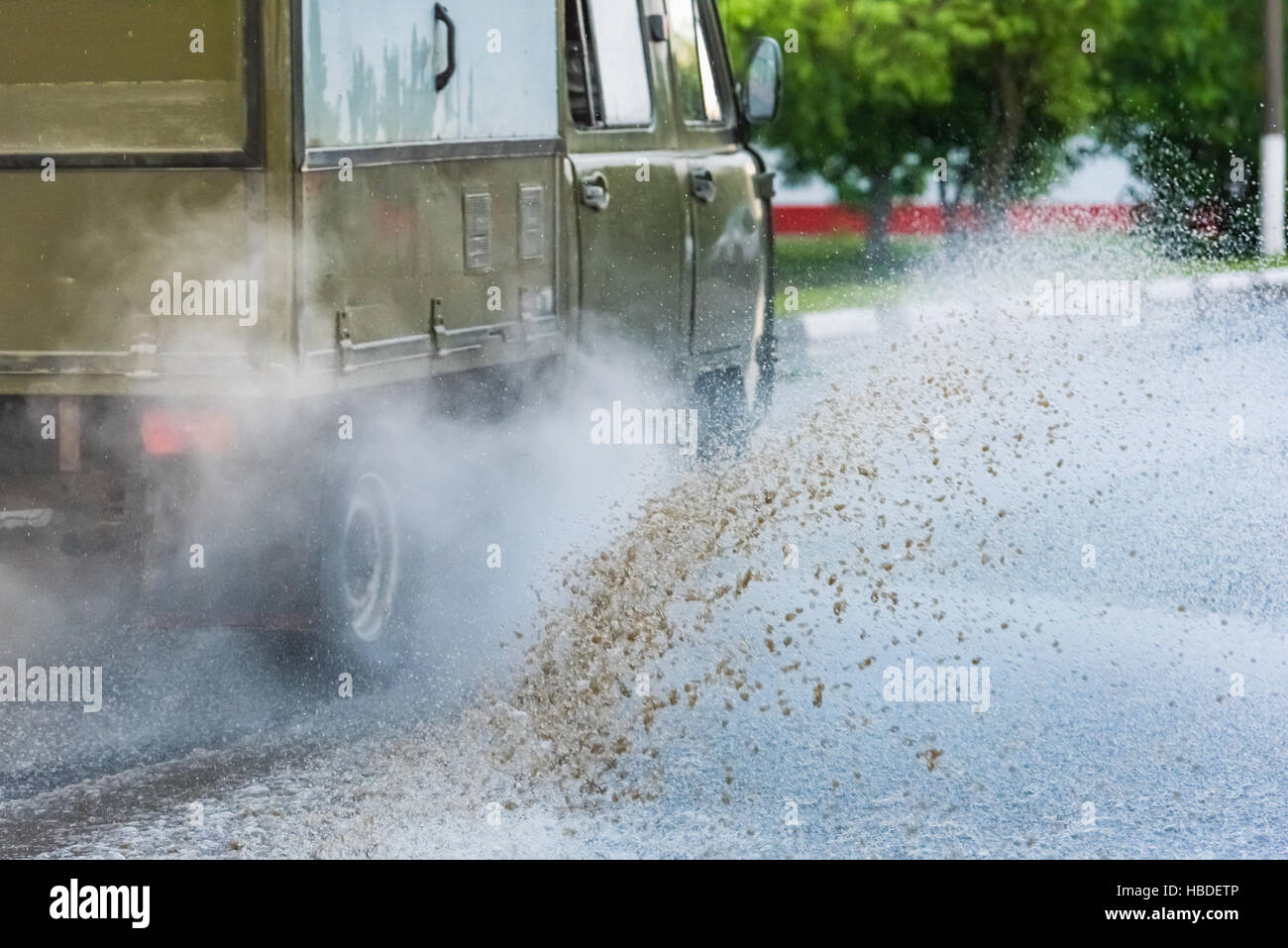 car rain puddle splashing water Stock Photo - Alamy
