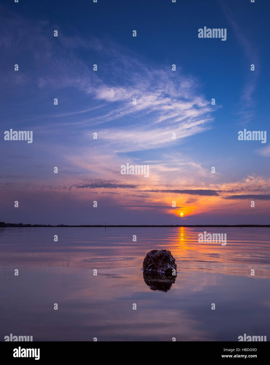 stone in the water at sunset Stock Photo - Alamy