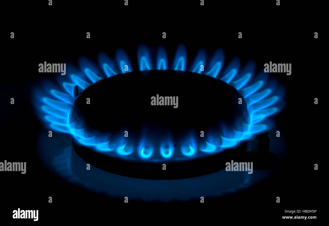 Natural gas burning a blue flames on black background Stock Photo - Alamy