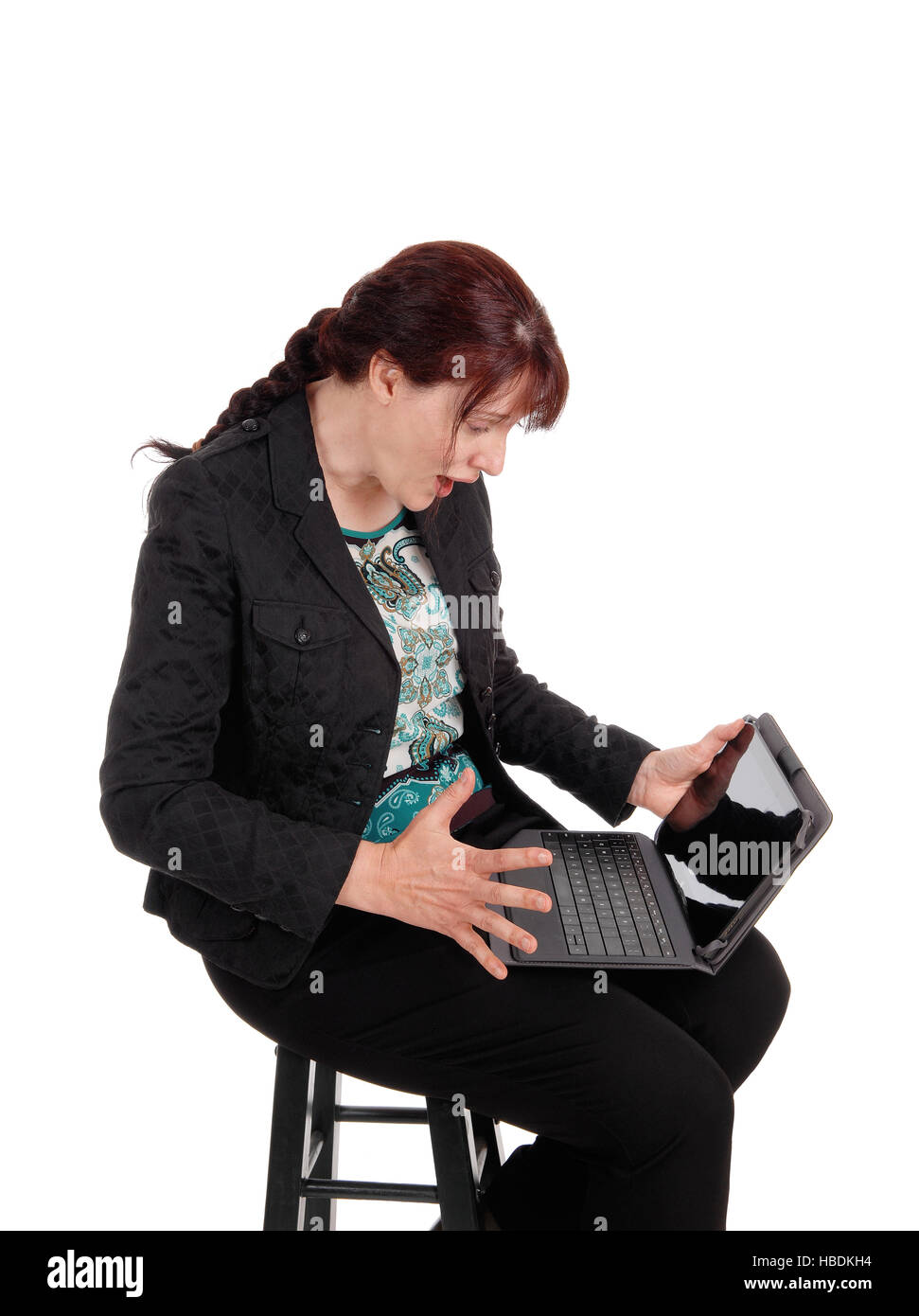 Woman wondering what is on laptop Stock Photo - Alamy