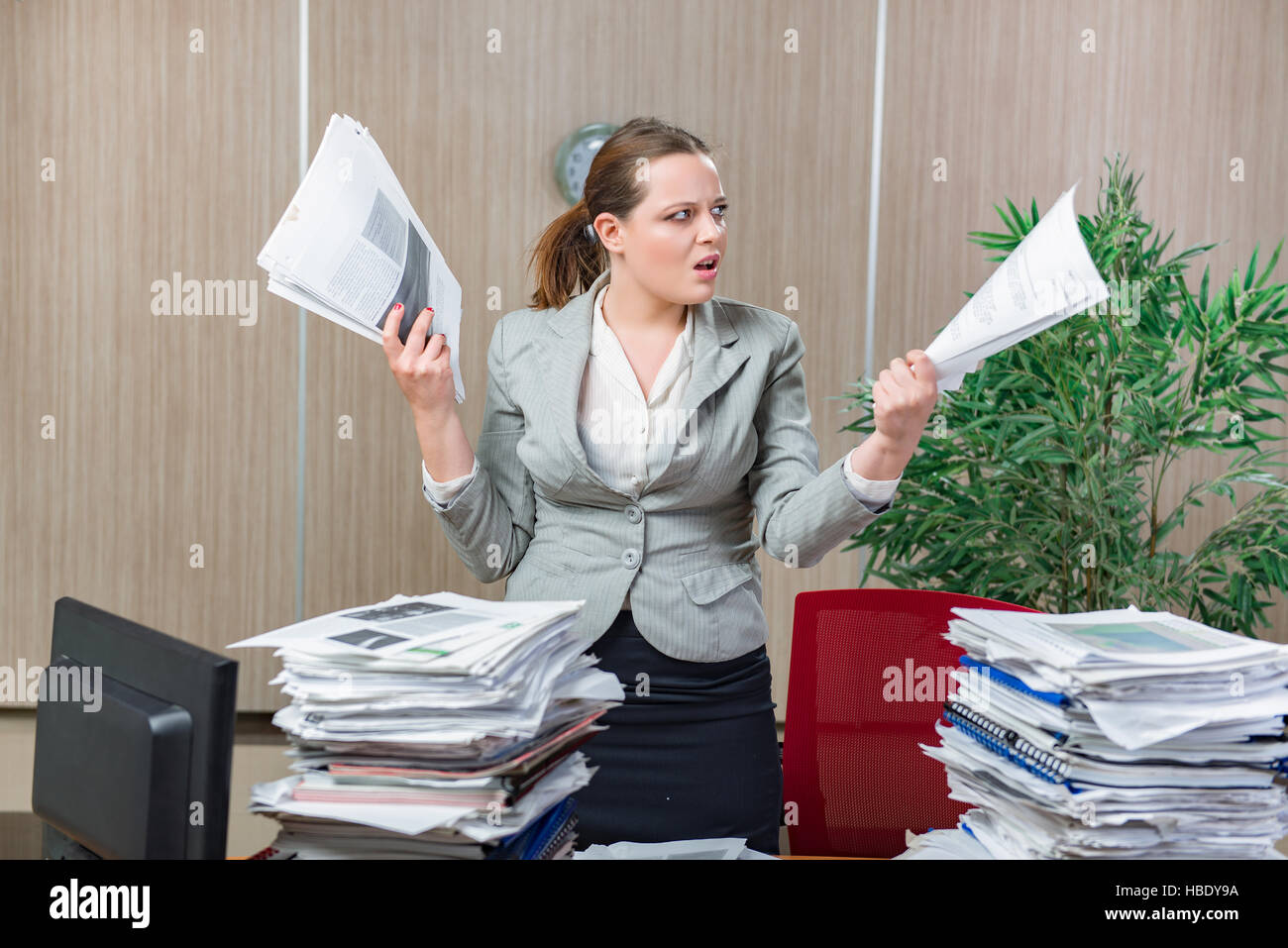 Woman under stress from excessive paper work Stock Photo - Alamy