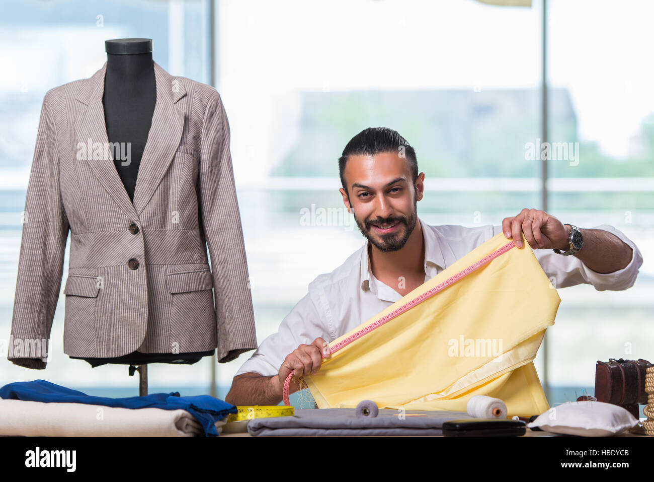 Young tailor working on new clothing design Stock Photo - Alamy
