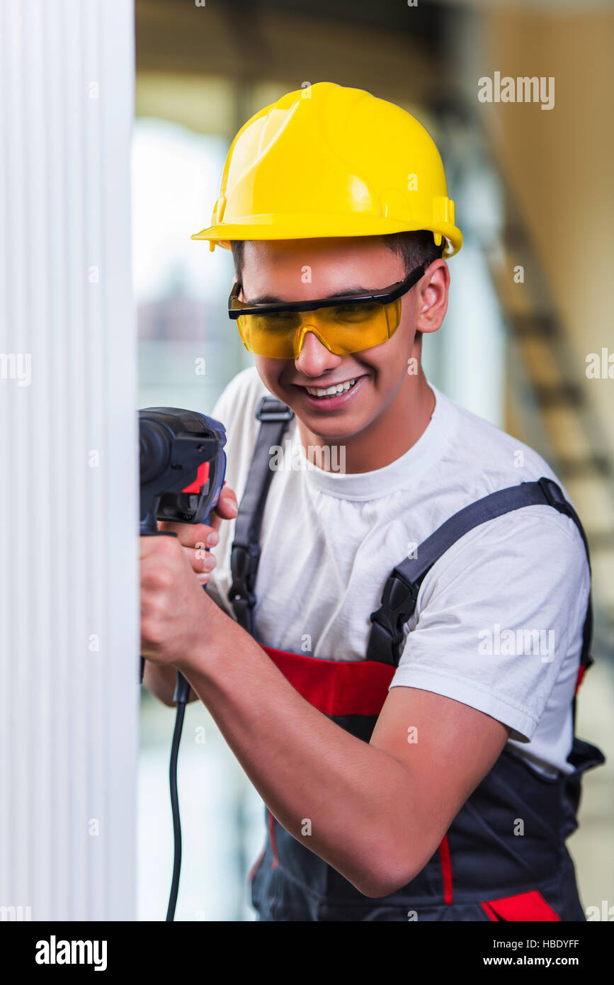 Man drilling the wall with drill perforator Stock Photo - Alamy