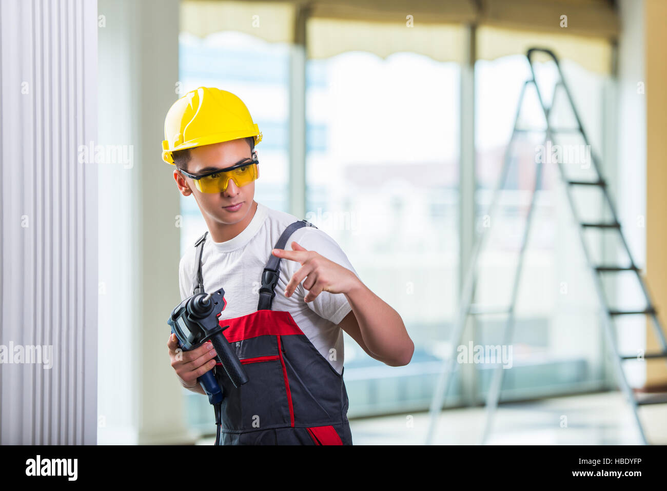 Man drilling the wall with drill perforator Stock Photo - Alamy